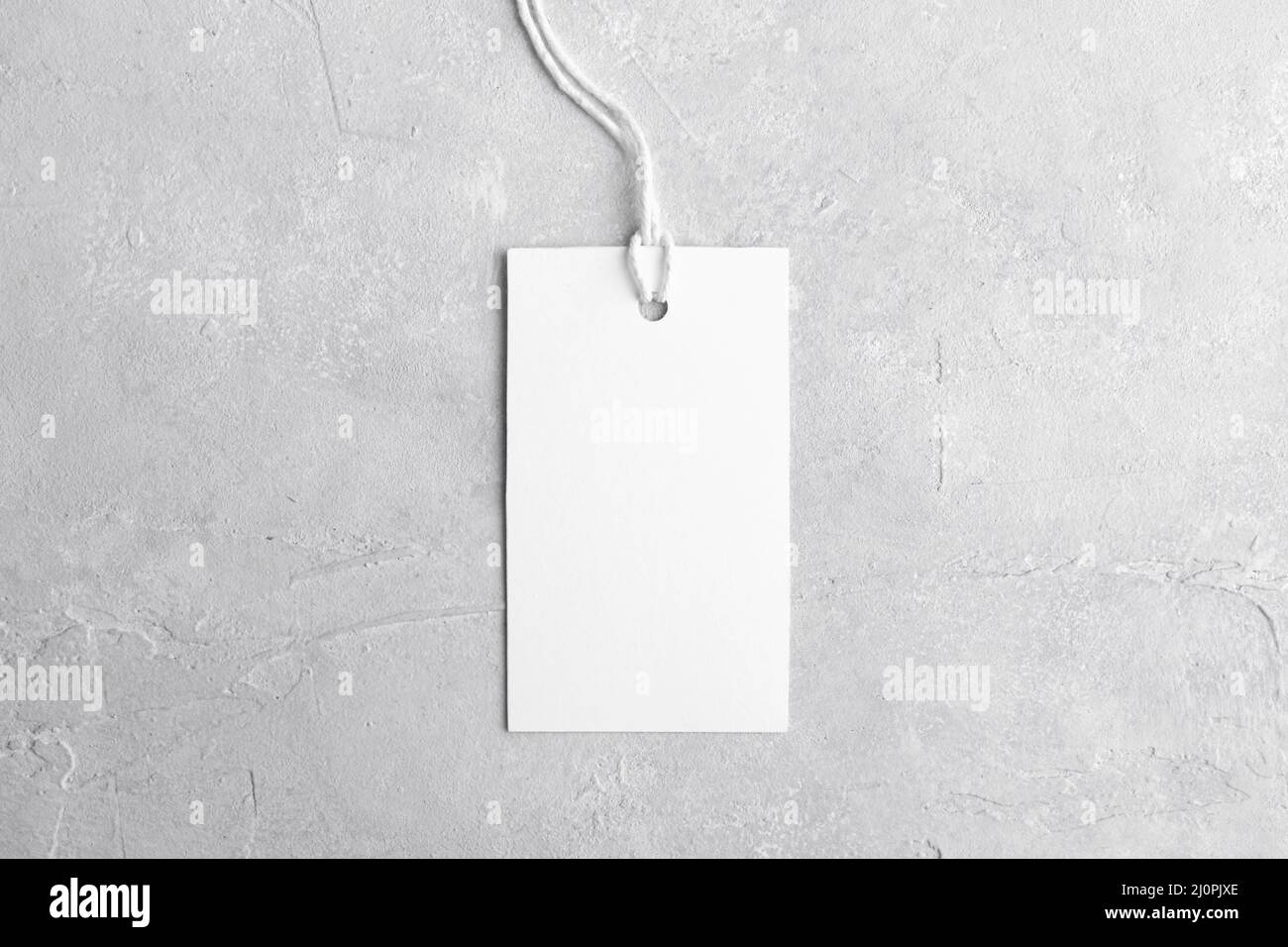 Rectangle white tag mockup with white cord, close up. Blank paper ...