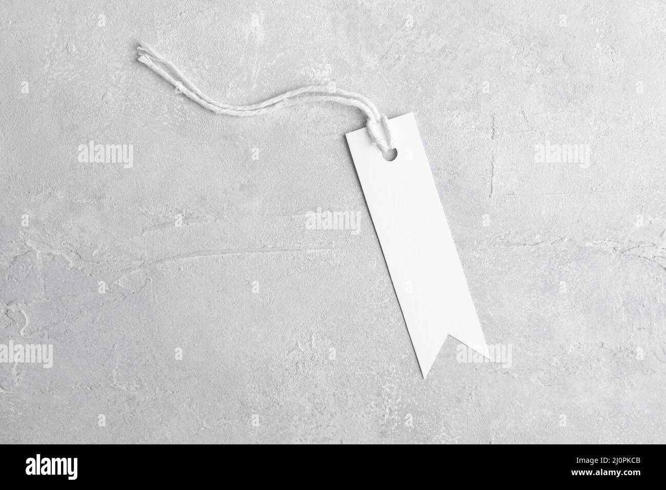 Rectangle strip white tag mockup with white cord, close up. Blank paper ...