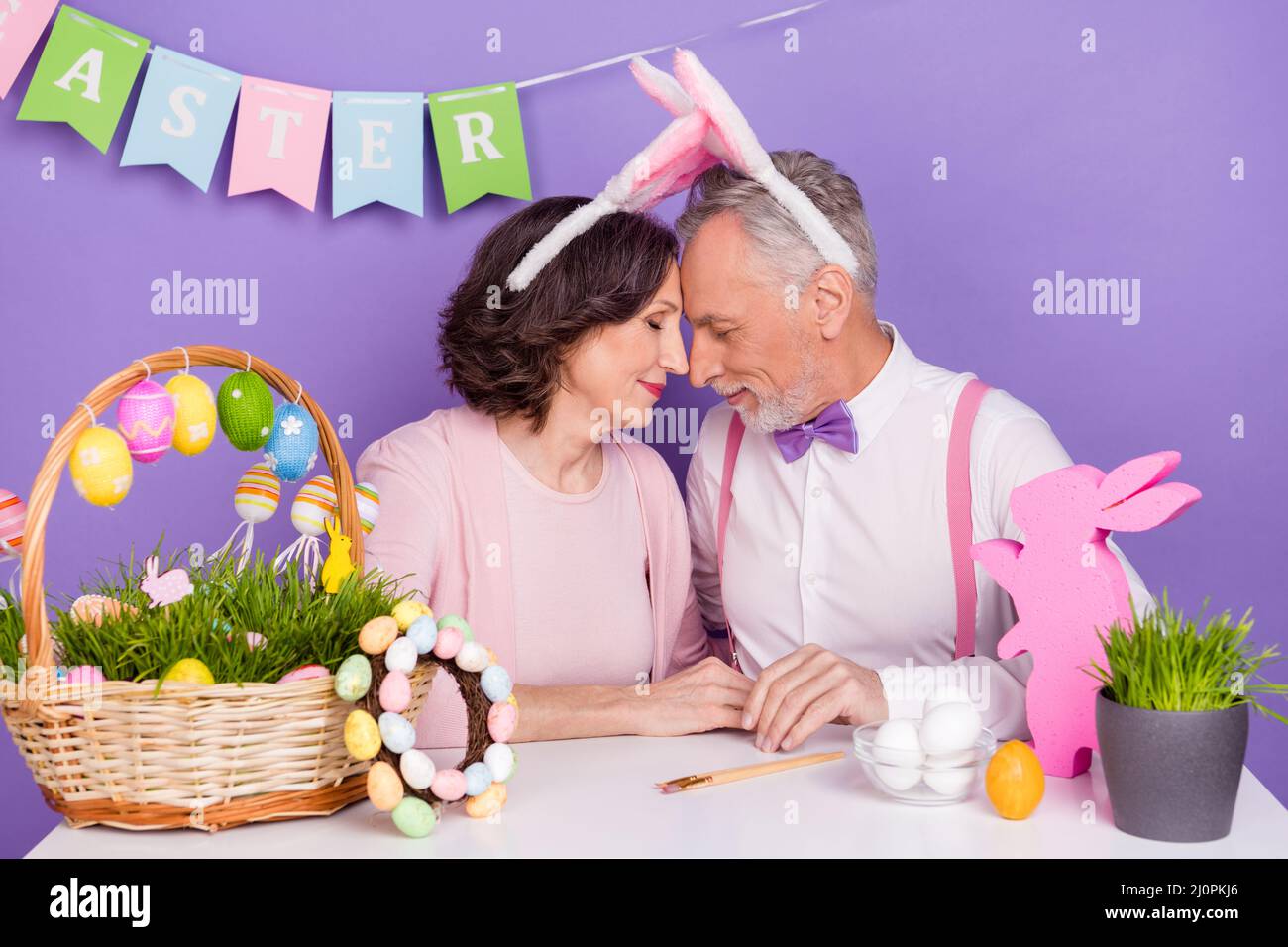 Photo of two idyllic peaceful aged people closed eyes touch heads ...