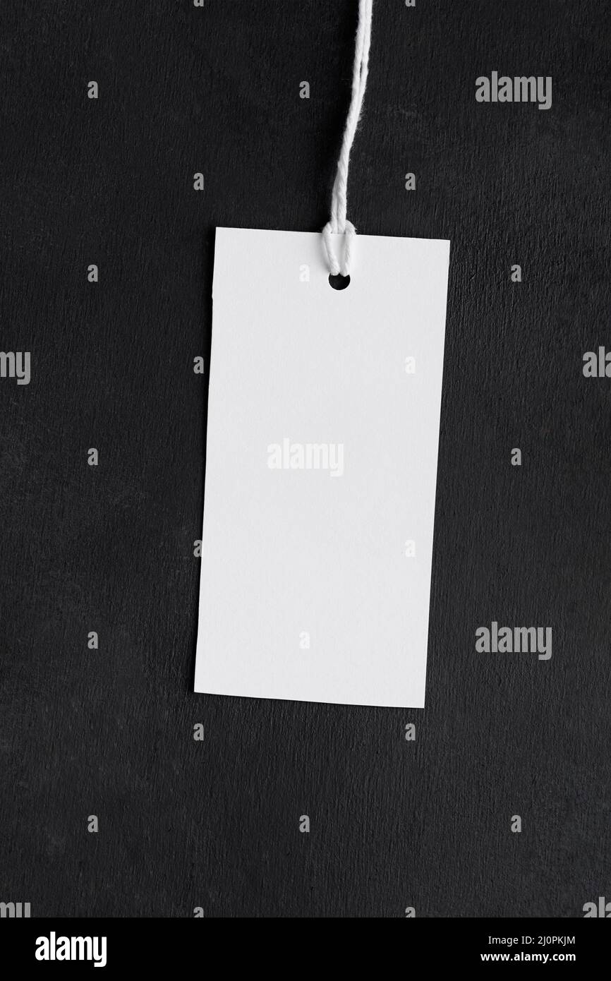 Rectangle white tag mockup with white cord, close up. Blank paper ...