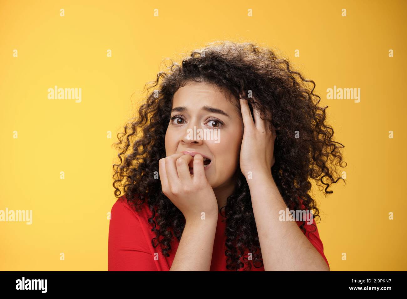 Scared woman overthinking frightened being in trouble biting fingers ...