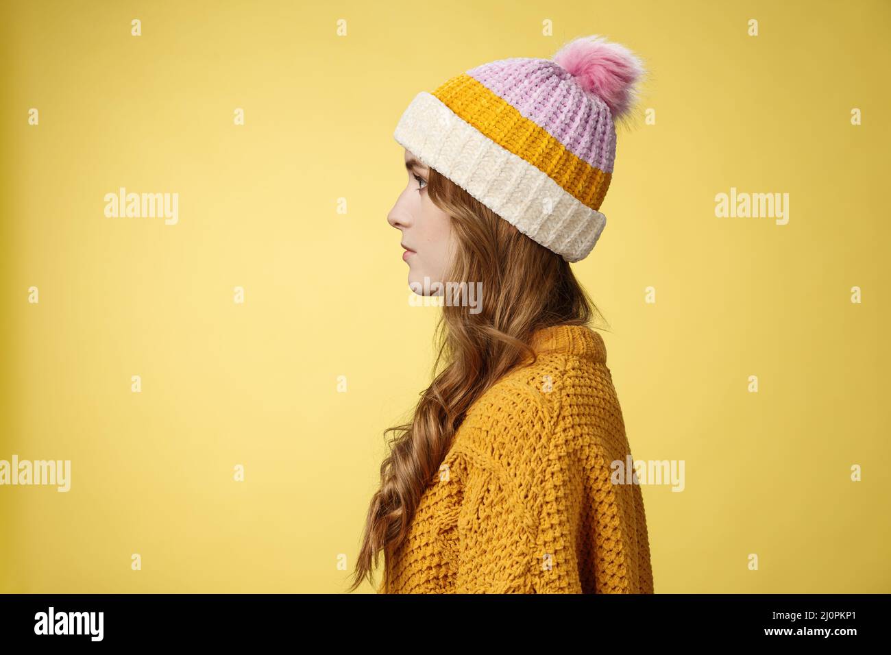 Profile shot attractive female curly hairstyle wearing hat knitted ...