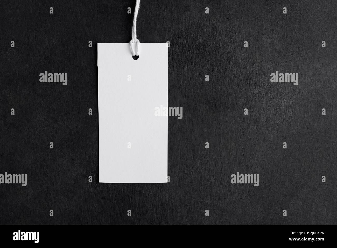 Rectangle white tag mockup with white cord, close up. Blank paper ...