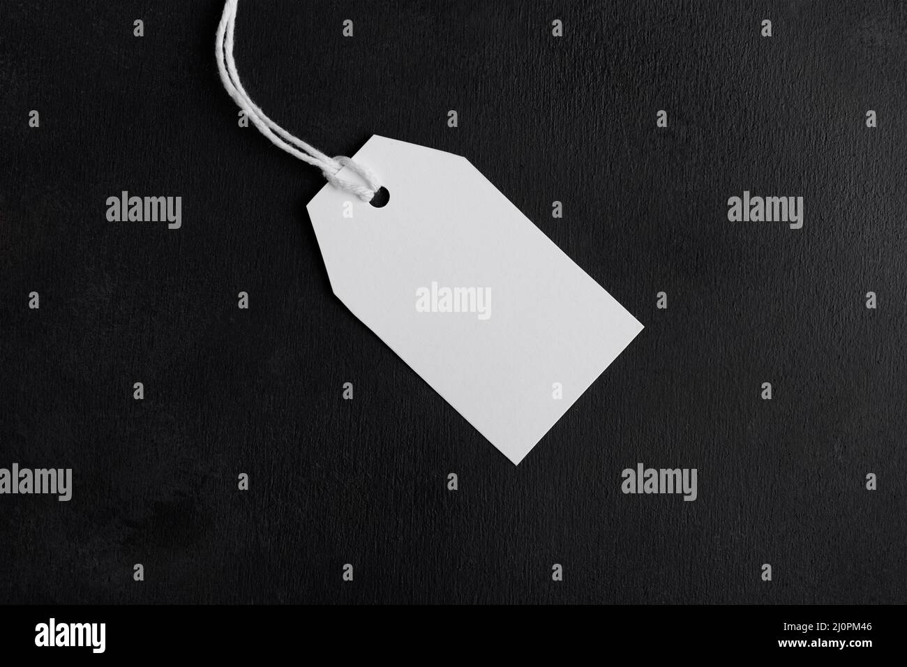 Rectangle white tag mockup with white cord, close up. Blank paper ...