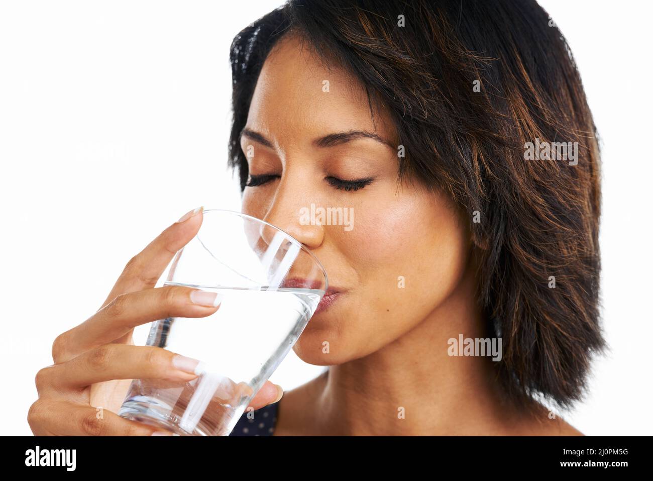 My lifestyle. Studio shot of an attractive young woman sipping a glass ...
