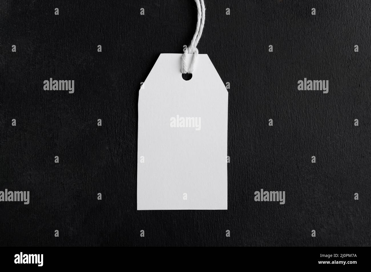 Rectangle white tag mockup with white cord, close up. Blank paper ...