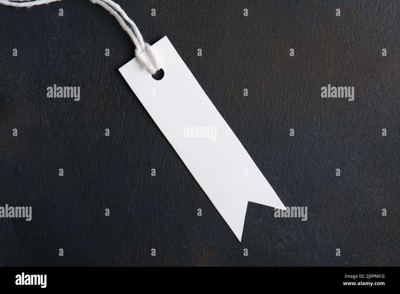 Rectangle strip white tag mockup with white cord, close up. Blank paper ...