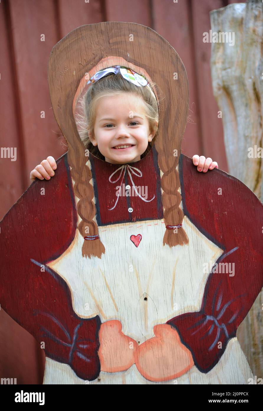 Smiling girl poking head through hi-res stock photography and images ...