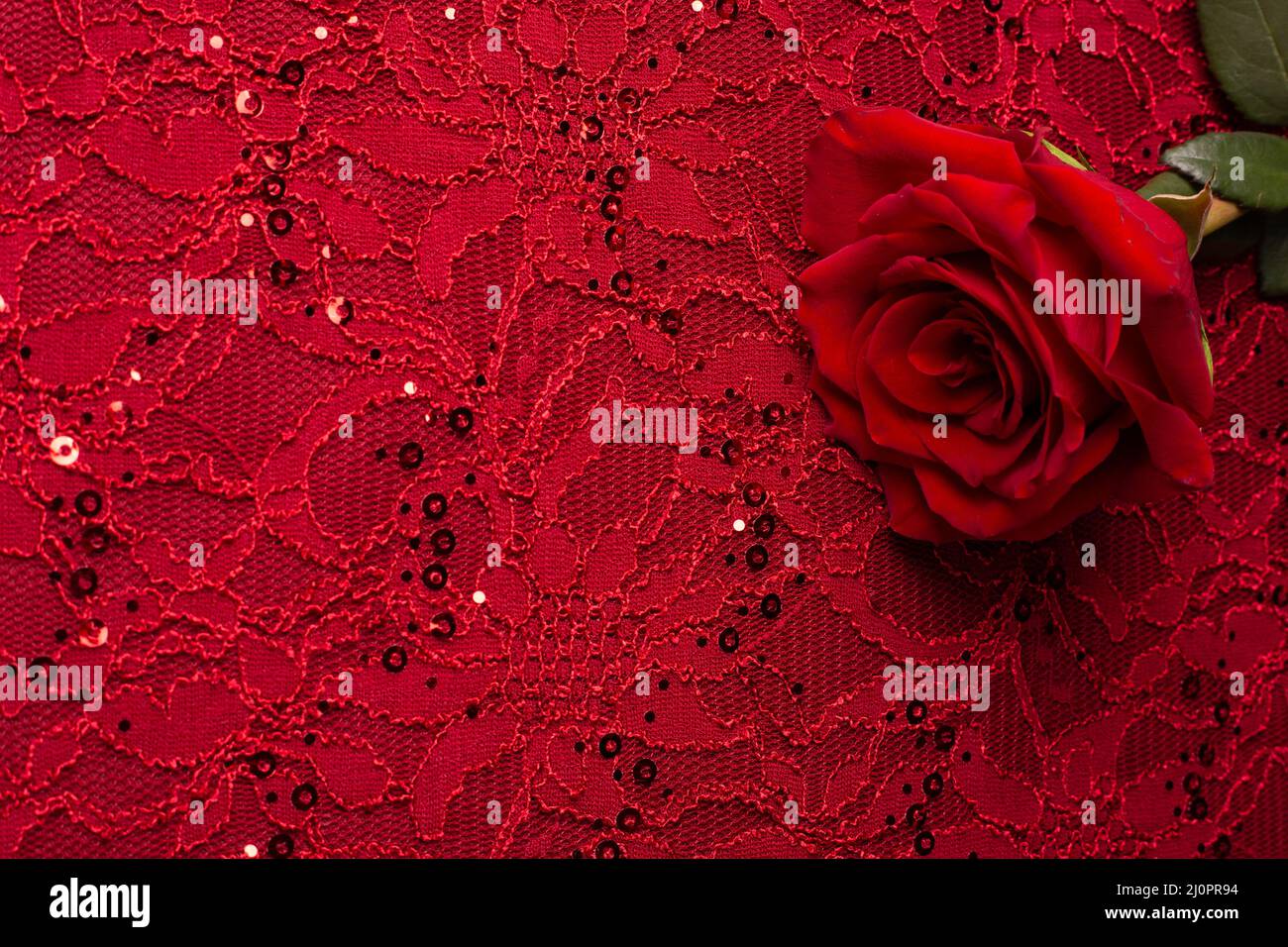 Red background with a lace pattern and rose Stock Photo - Alamy