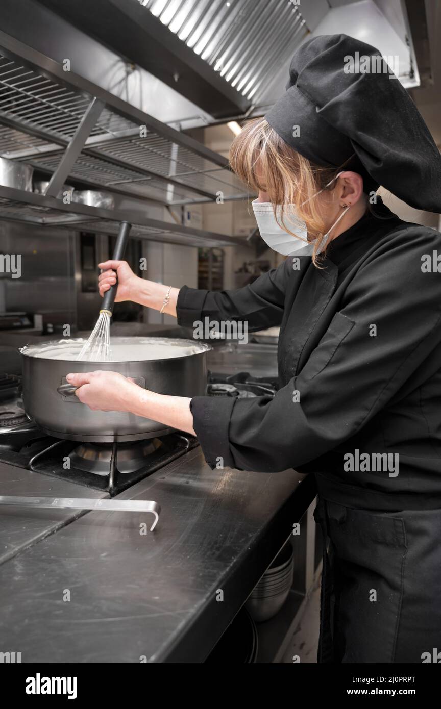 Portrait of confident female chef working in commercial kitchen Stock ...