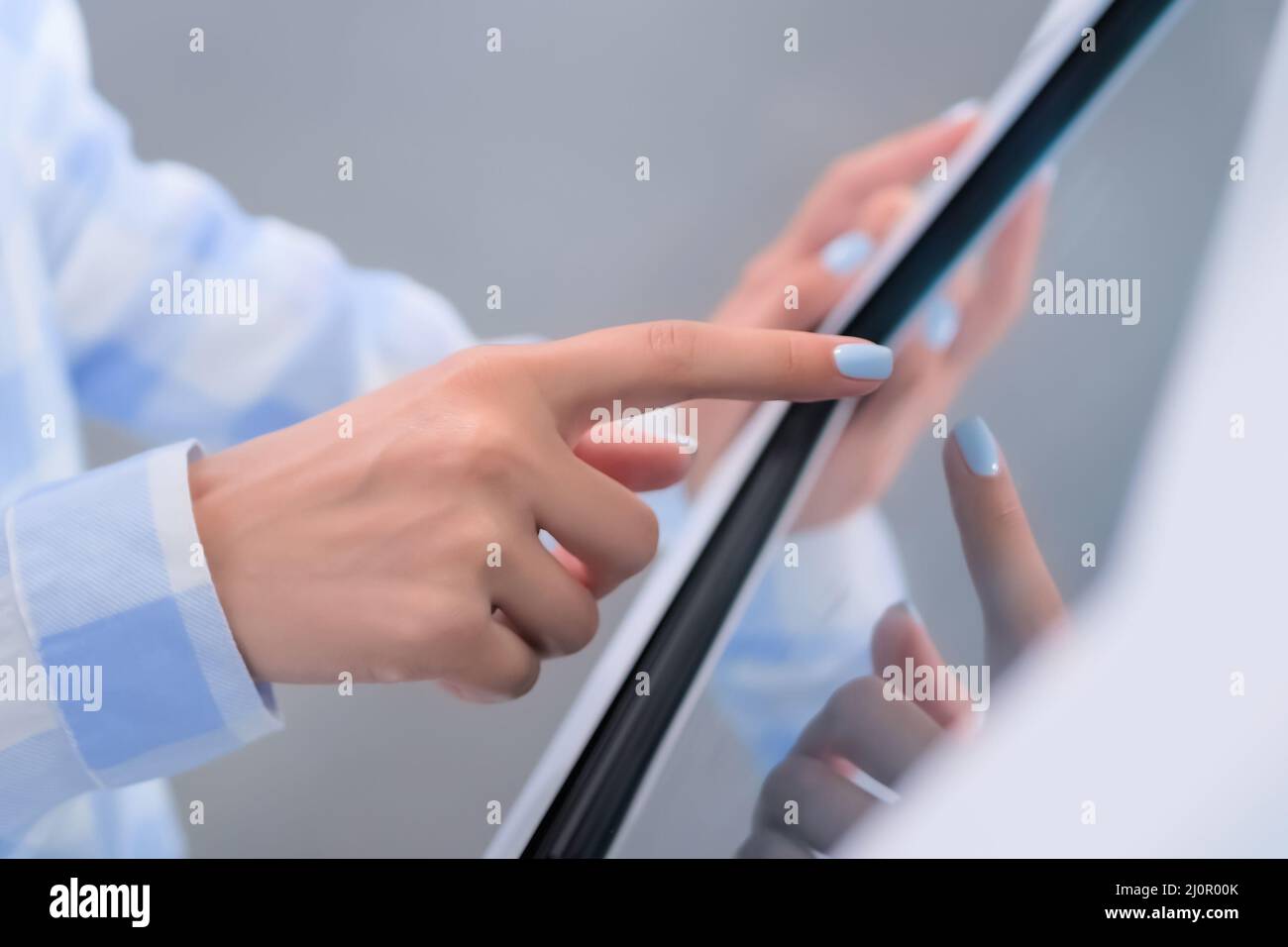 Close up: woman using touchscreen display of interactive kiosk at ...