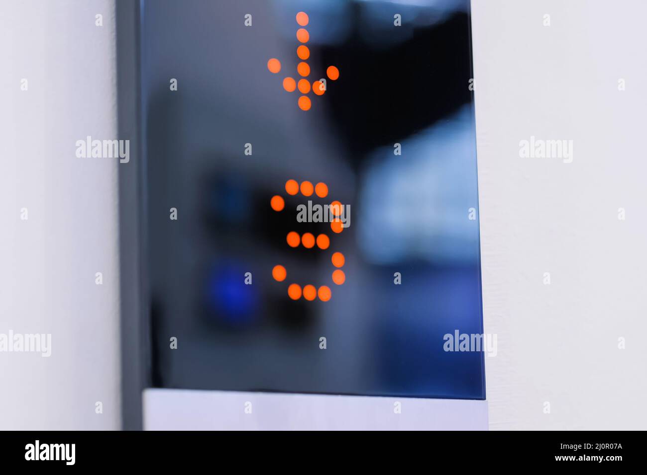 Digital elevator display showing floor number - 3 - lift going down ...