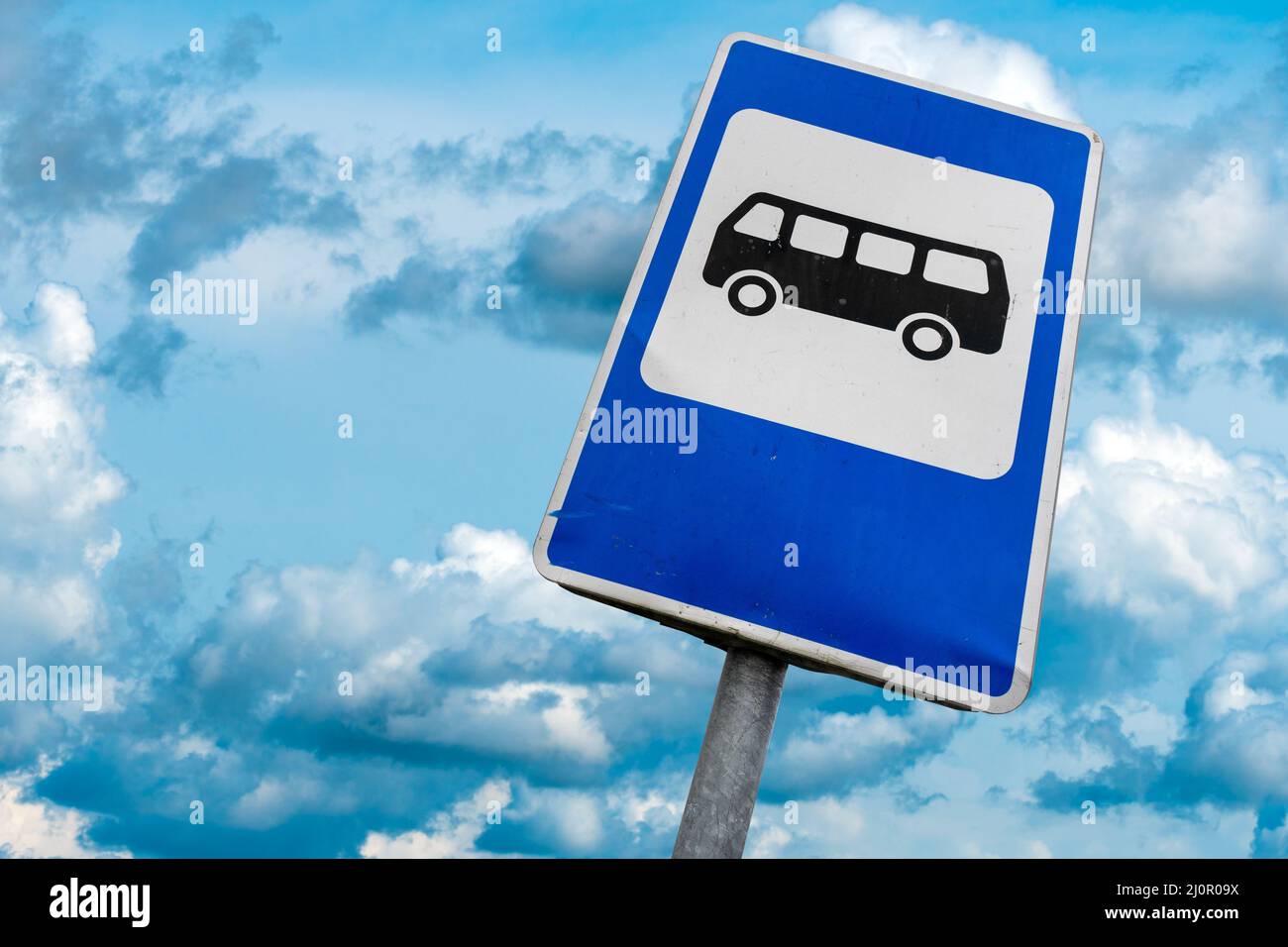 Bus stop sign in front of cloudy sky Stock Photo - Alamy