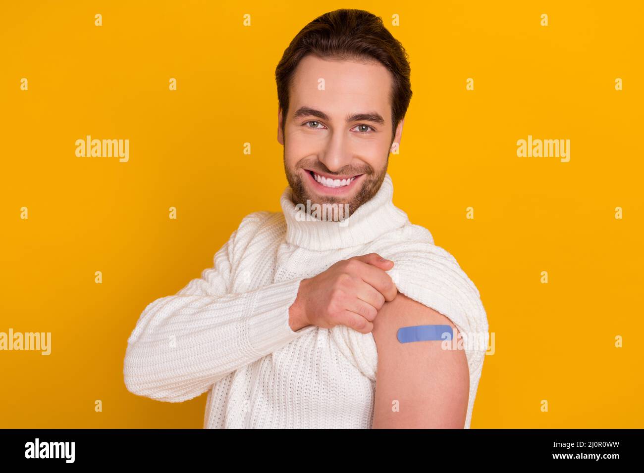 Photo of positive guy demonstrate shoulder injection effect wear white ...