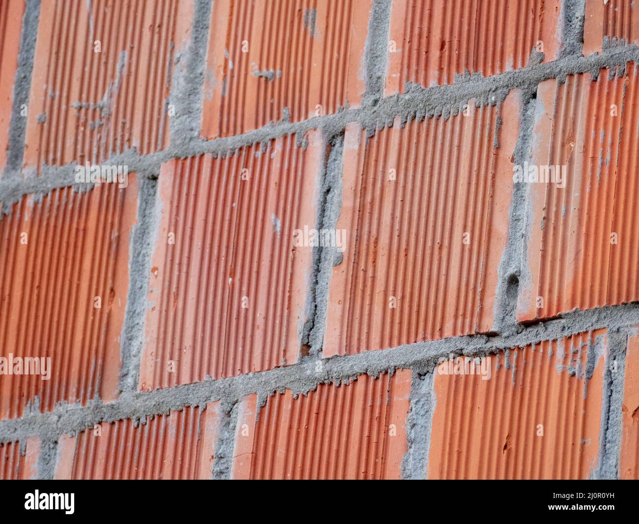 Texture of a wall built with ceramic Porotherm bricks - orange brick ...
