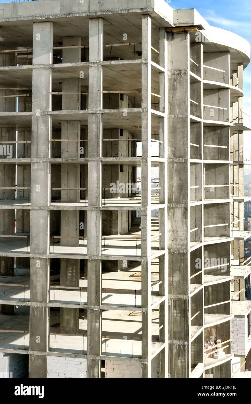 Aerial view of concrete frame of tall apartment building under ...