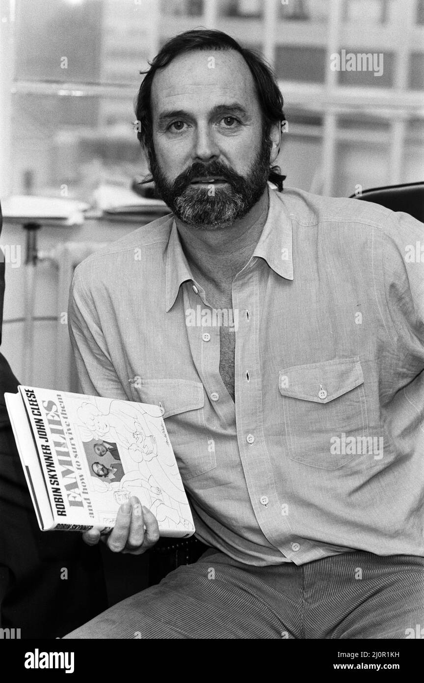 John Cleese with a copy of his book "Families And How To Survive Them ...