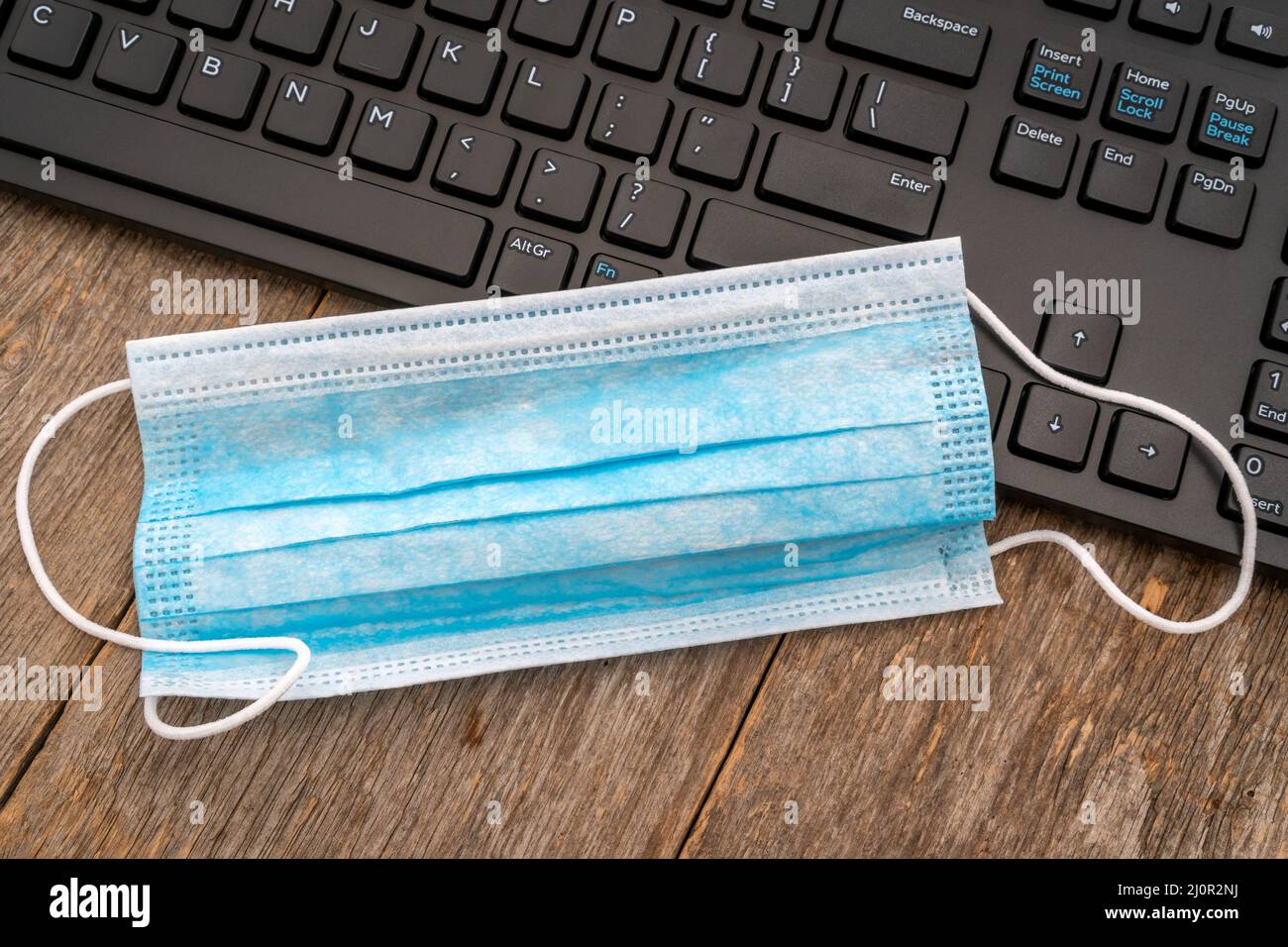 Surgical mask are placed on computer keyboard Stock Photo - Alamy
