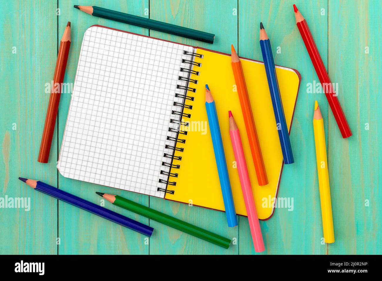 Spiral notebook and colored drawing pencils Stock Photo - Alamy