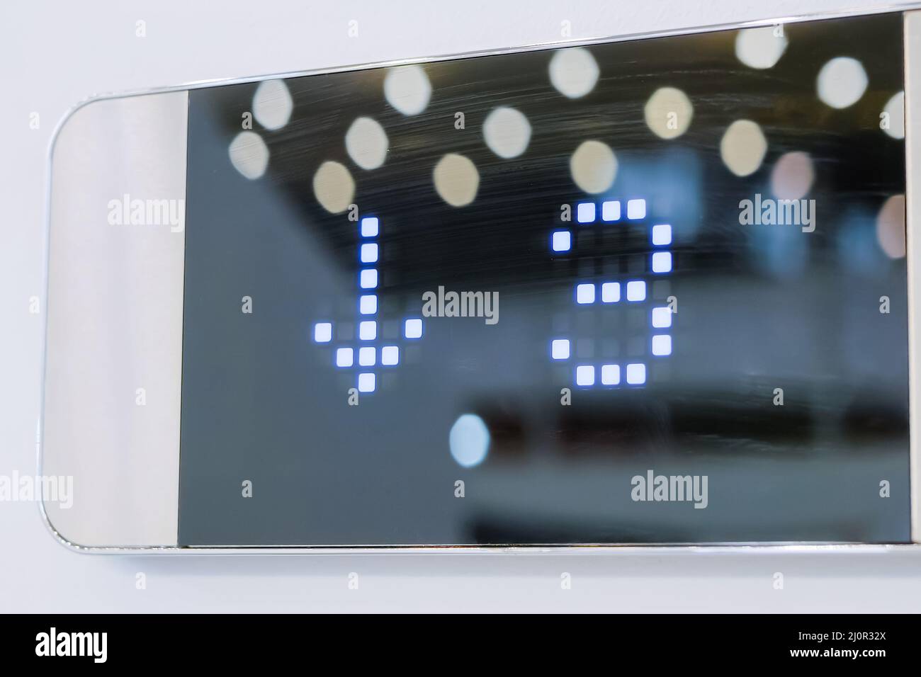 Digital elevator display showing floor number - 3: lift going down ...