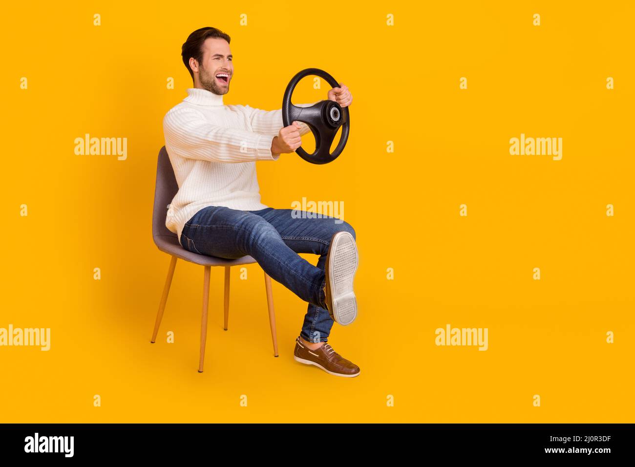 Photo of shocked impressed guy dressed white sweater riding car leg ...