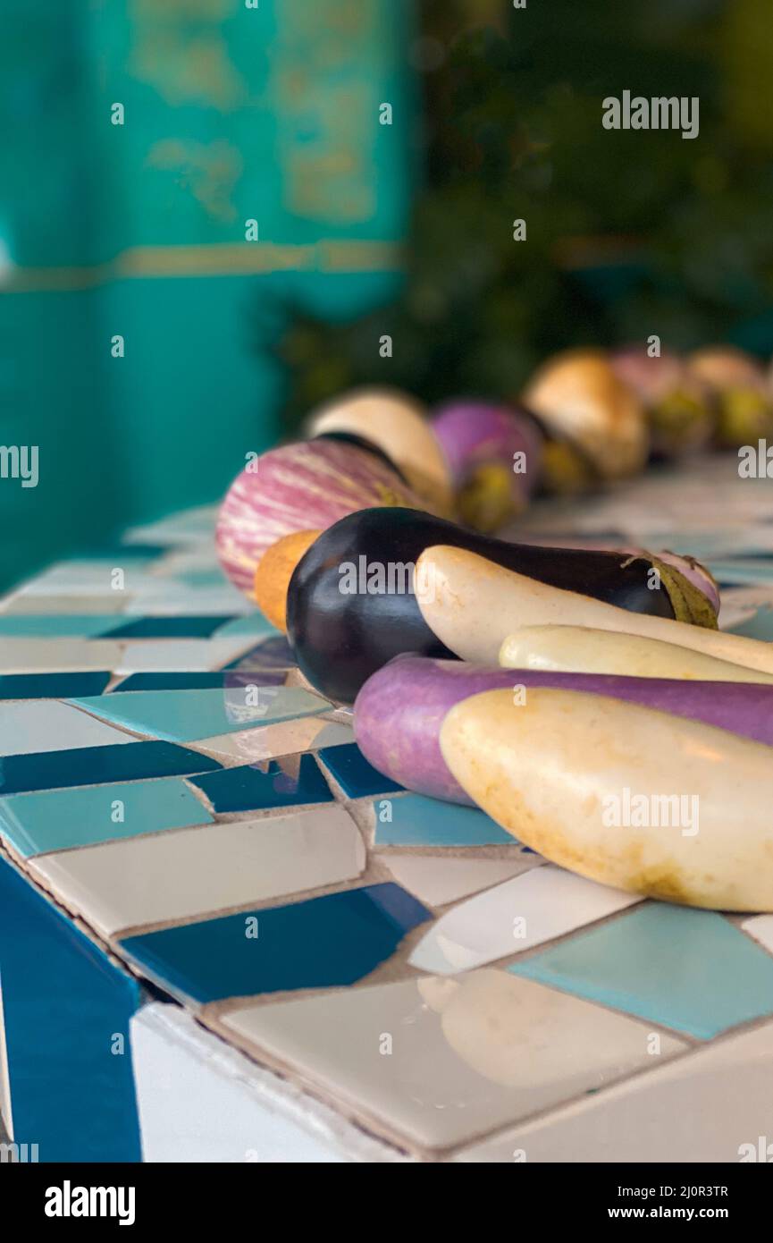Selective of a line of vegetables on a curving table Stock Photo - Alamy