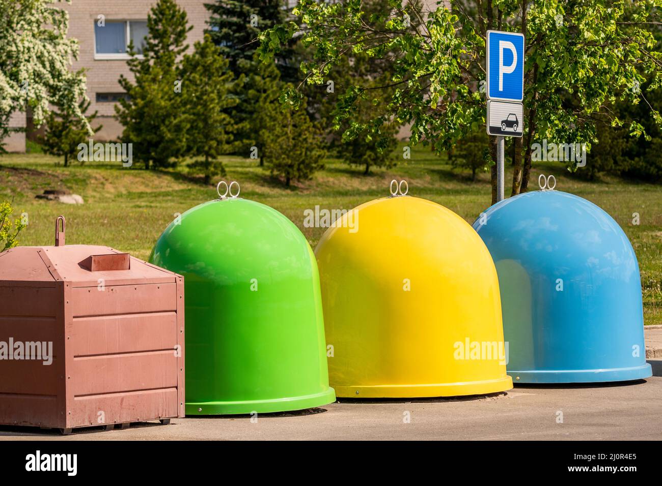 The different colored bins in the parking lot for collection of ...