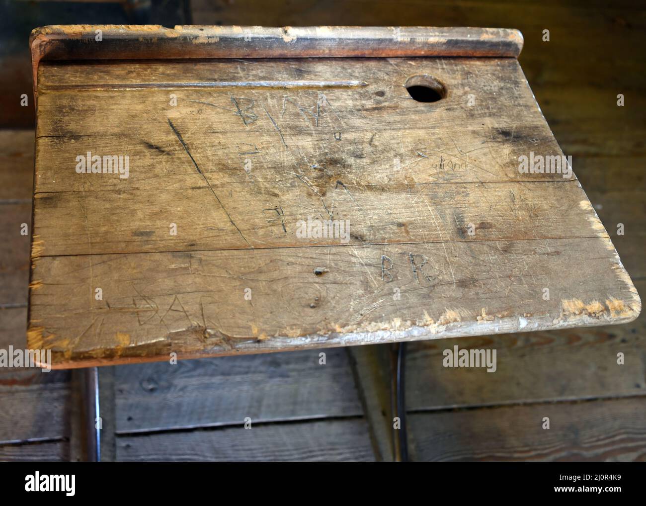 Scarred and Scratched, wooden, school desk sits in restored school ...