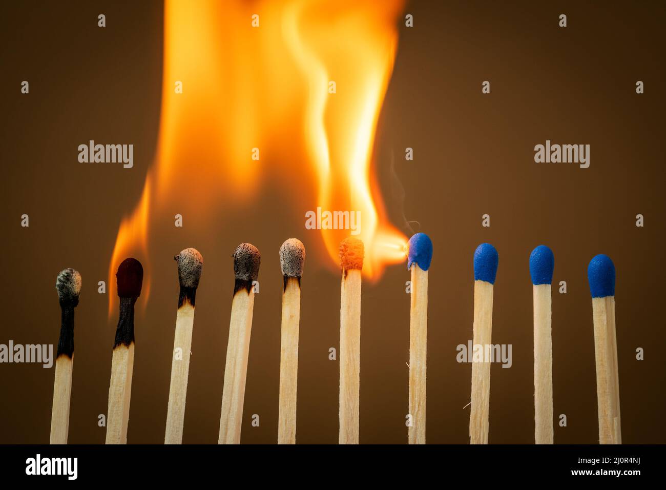 Group of match burn spread fire on dark background Stock Photo - Alamy