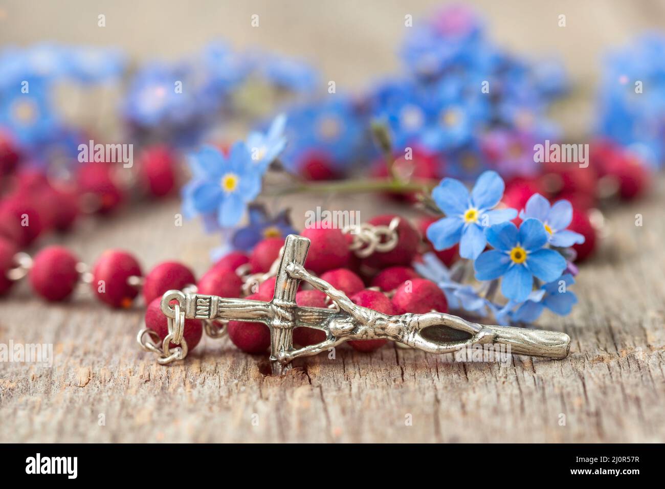 Rosary and blue flowers Stock Photo - Alamy