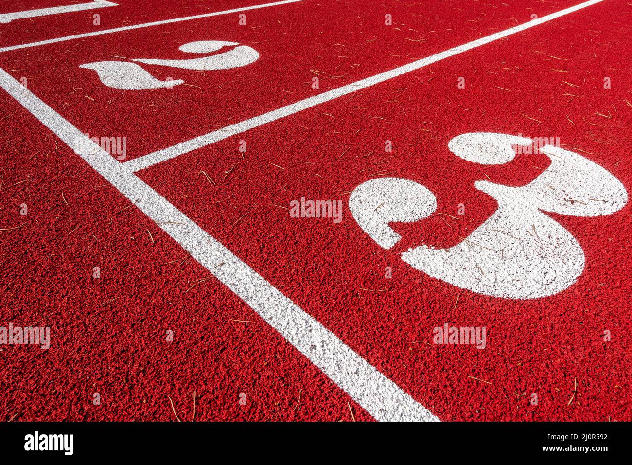 Numbers on start point of running track background Stock Photo - Alamy