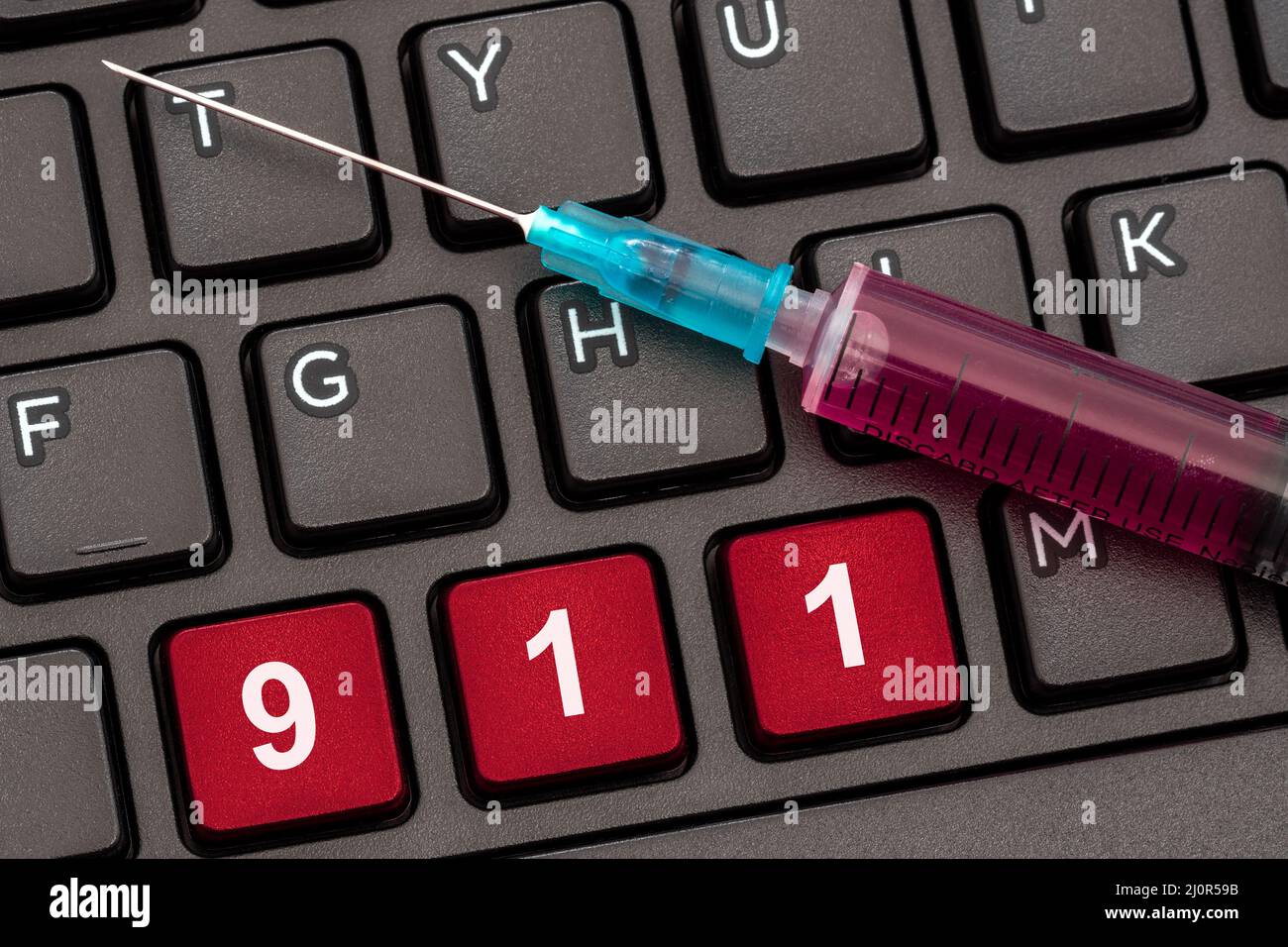 Keyboard with syringe and emergency number 911 Stock Photo - Alamy
