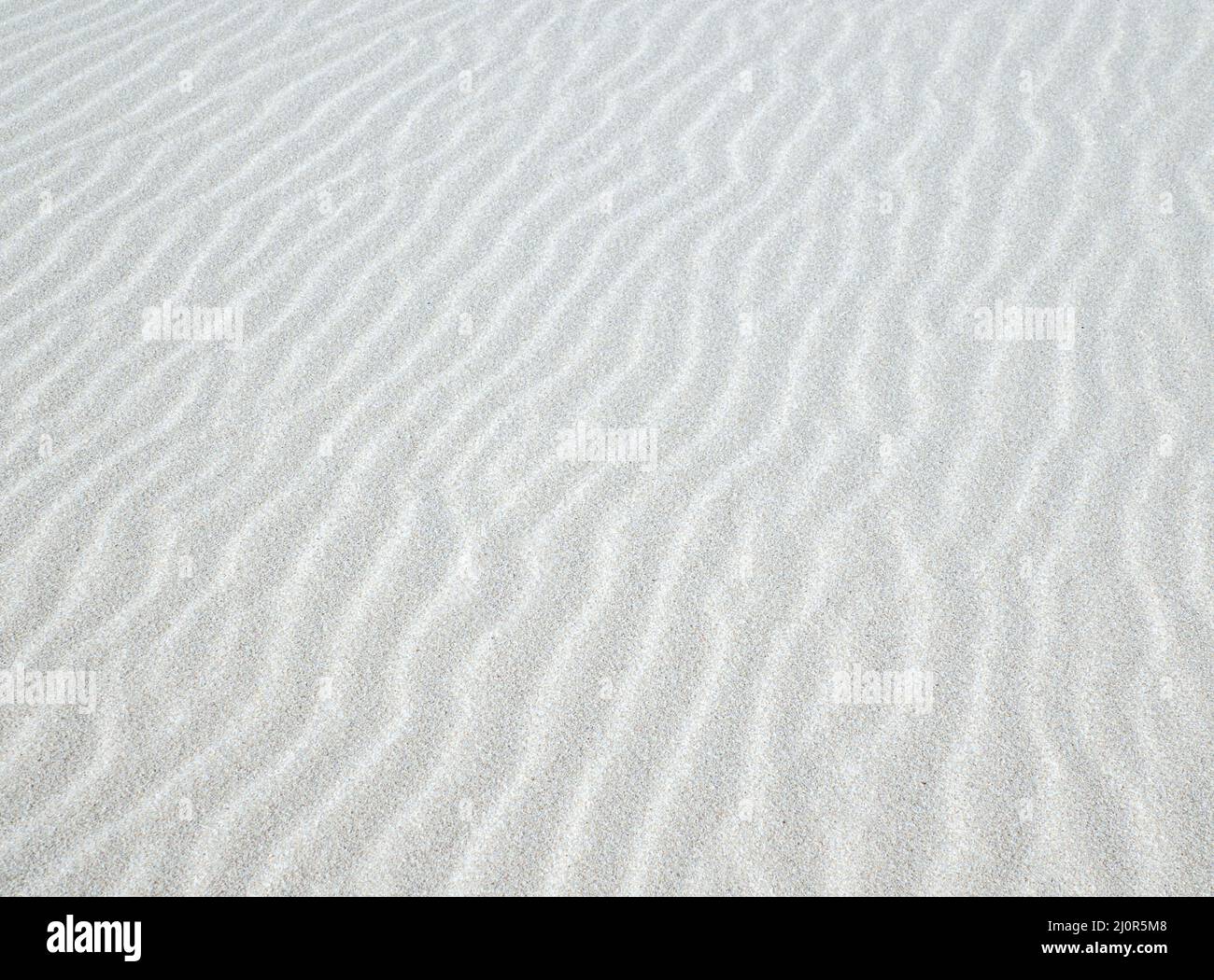 Rippled, wavy white sand background texture pattern Stock Photo - Alamy