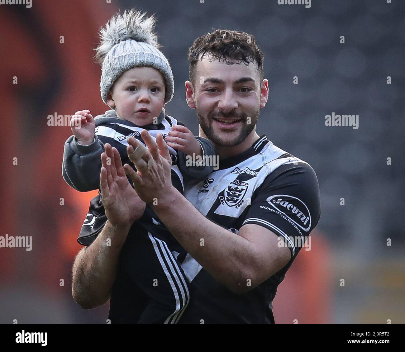 Jake Connor #1 of Hull FC celebrates the win with his children on the ...
