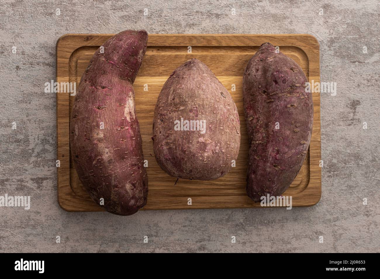 Sweet purple potato tubers close up, top view Stock Photo - Alamy