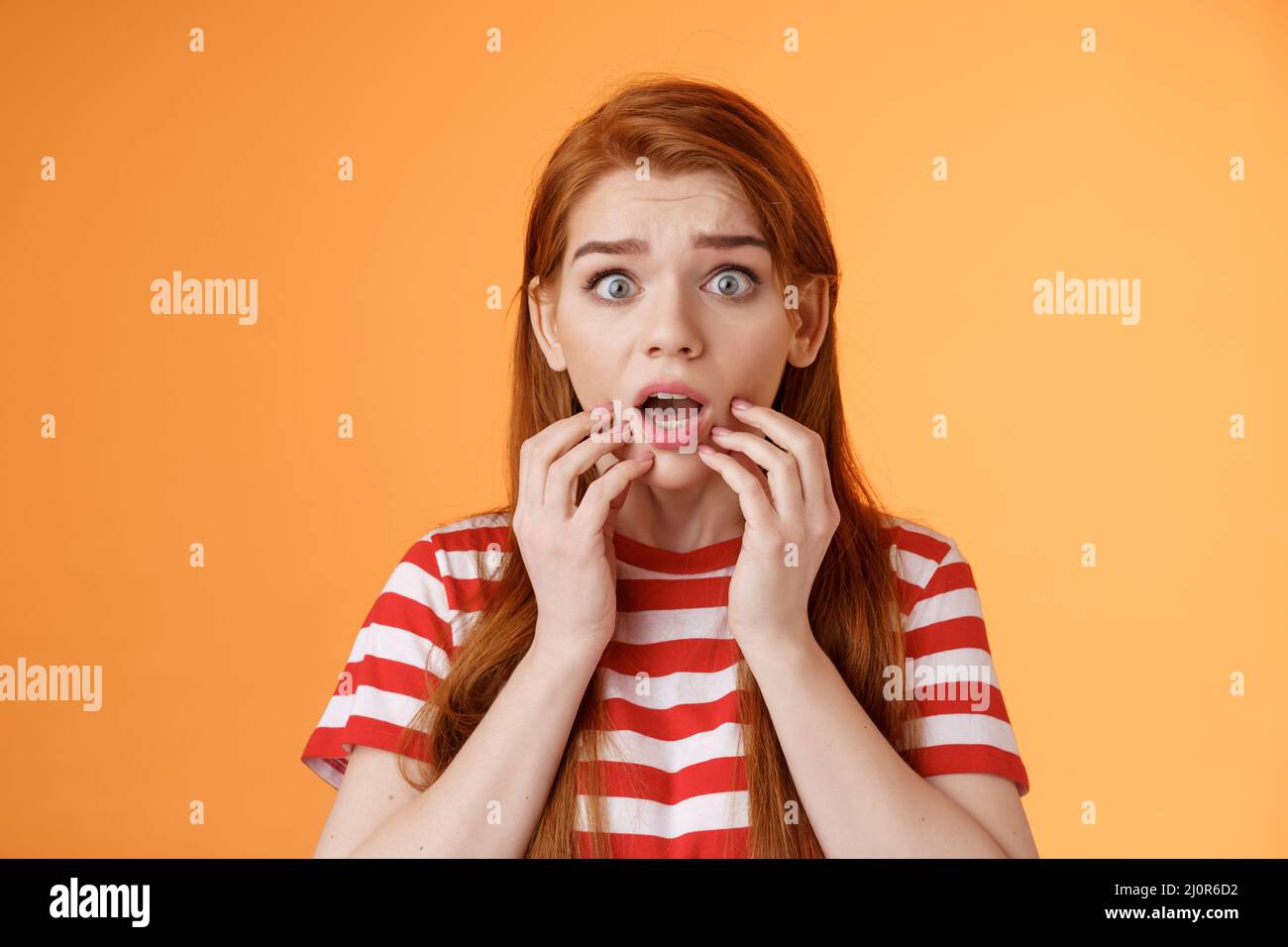 Scared shocked redhead woman worry, stare camera speechless gasping ...