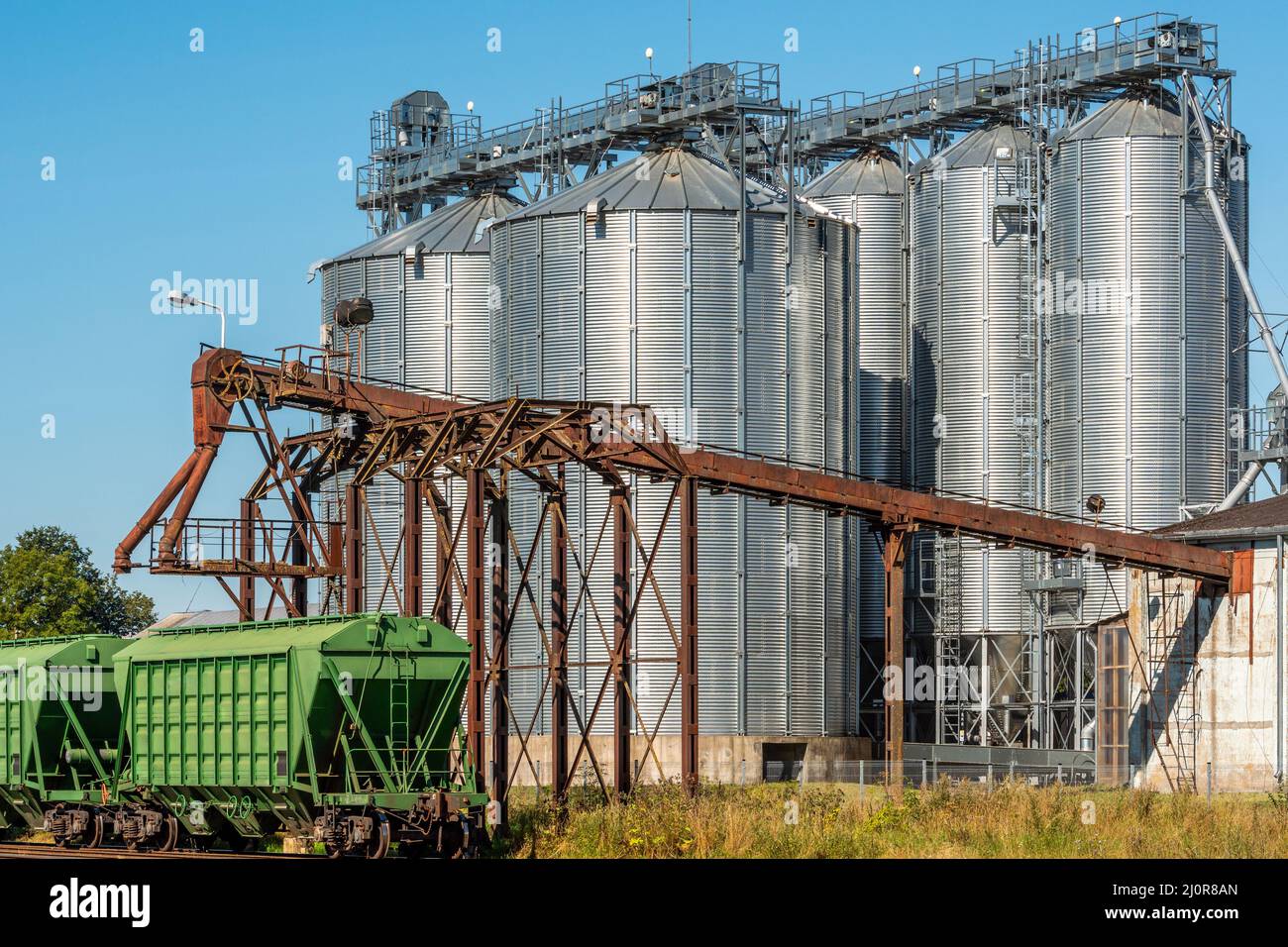 Loading railway wagon standing near the elevator in agriculture zone ...