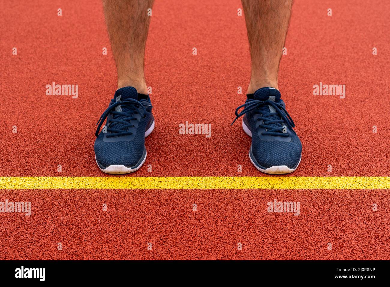 Man standing behind the yellow line in the sports ground Stock Photo ...