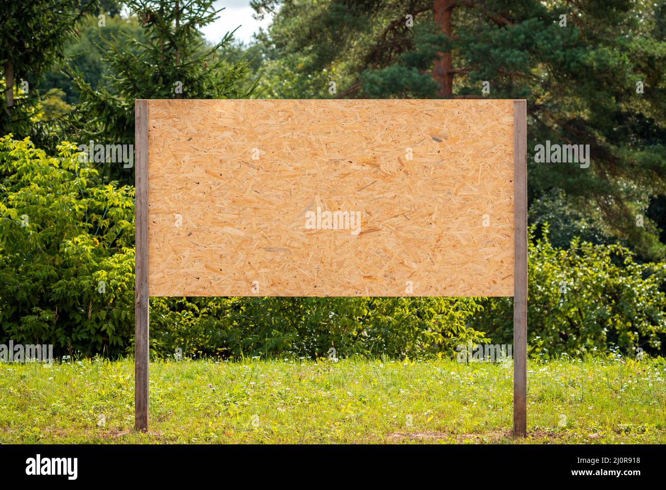 Wooden blank billboard with empty space in a park Stock Photo - Alamy