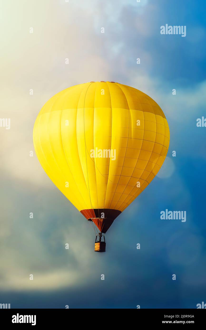 Big yellow hot air balloon high in the sky Stock Photo - Alamy