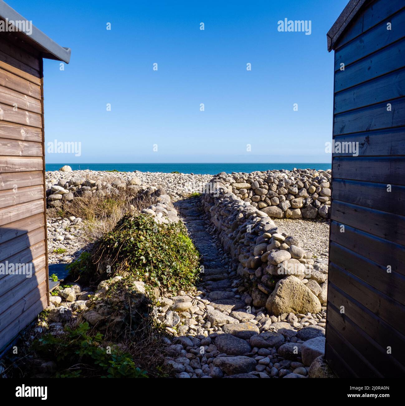 Beach huts and 'front gardens' at Church Ope Cove a secluded beach and ...