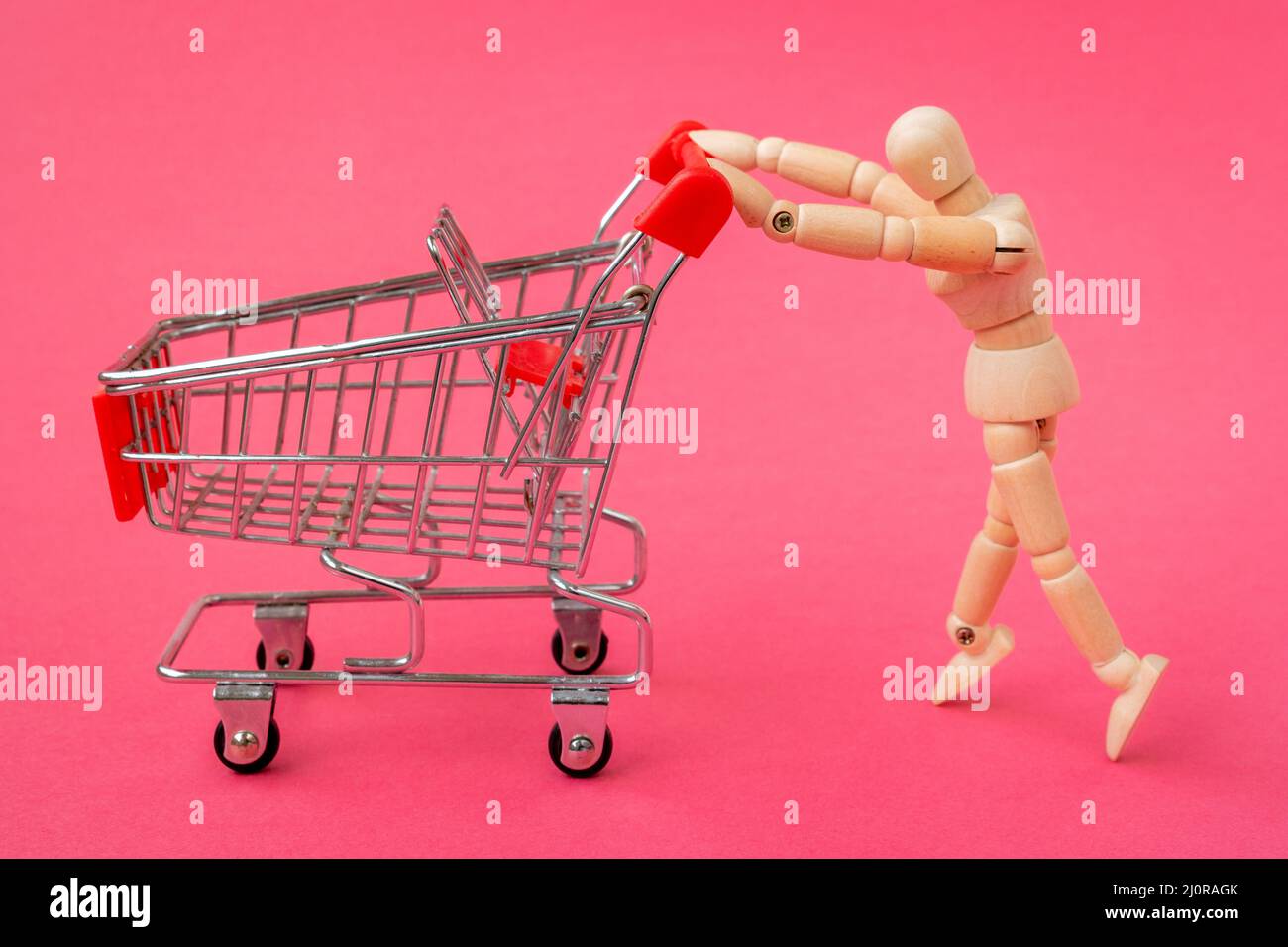 Dummy pushing an empty shopping cart Stock Photo - Alamy