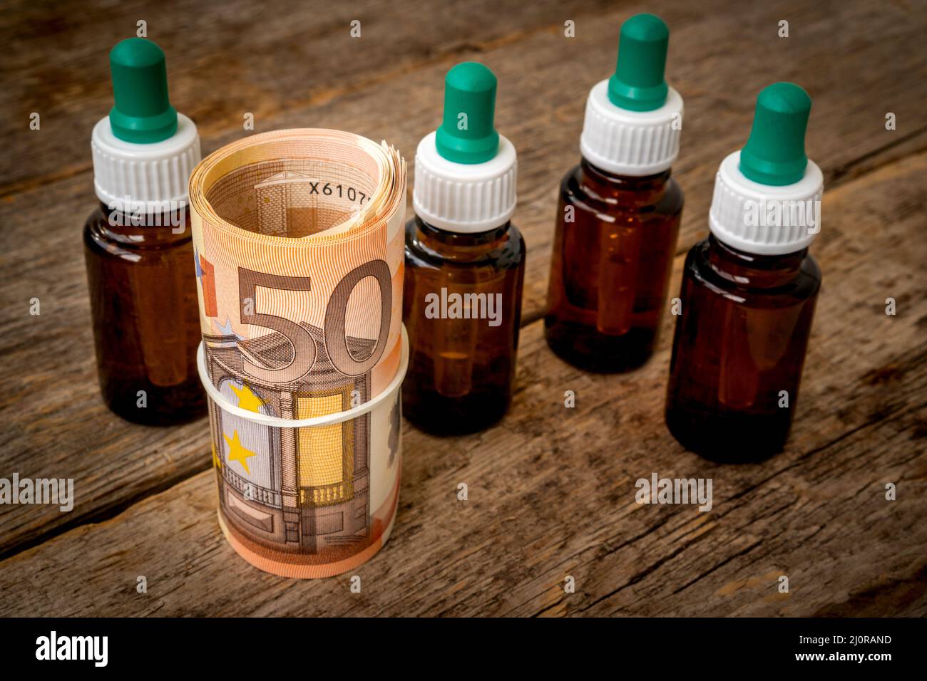 Medicine bottles and money roll Stock Photo - Alamy