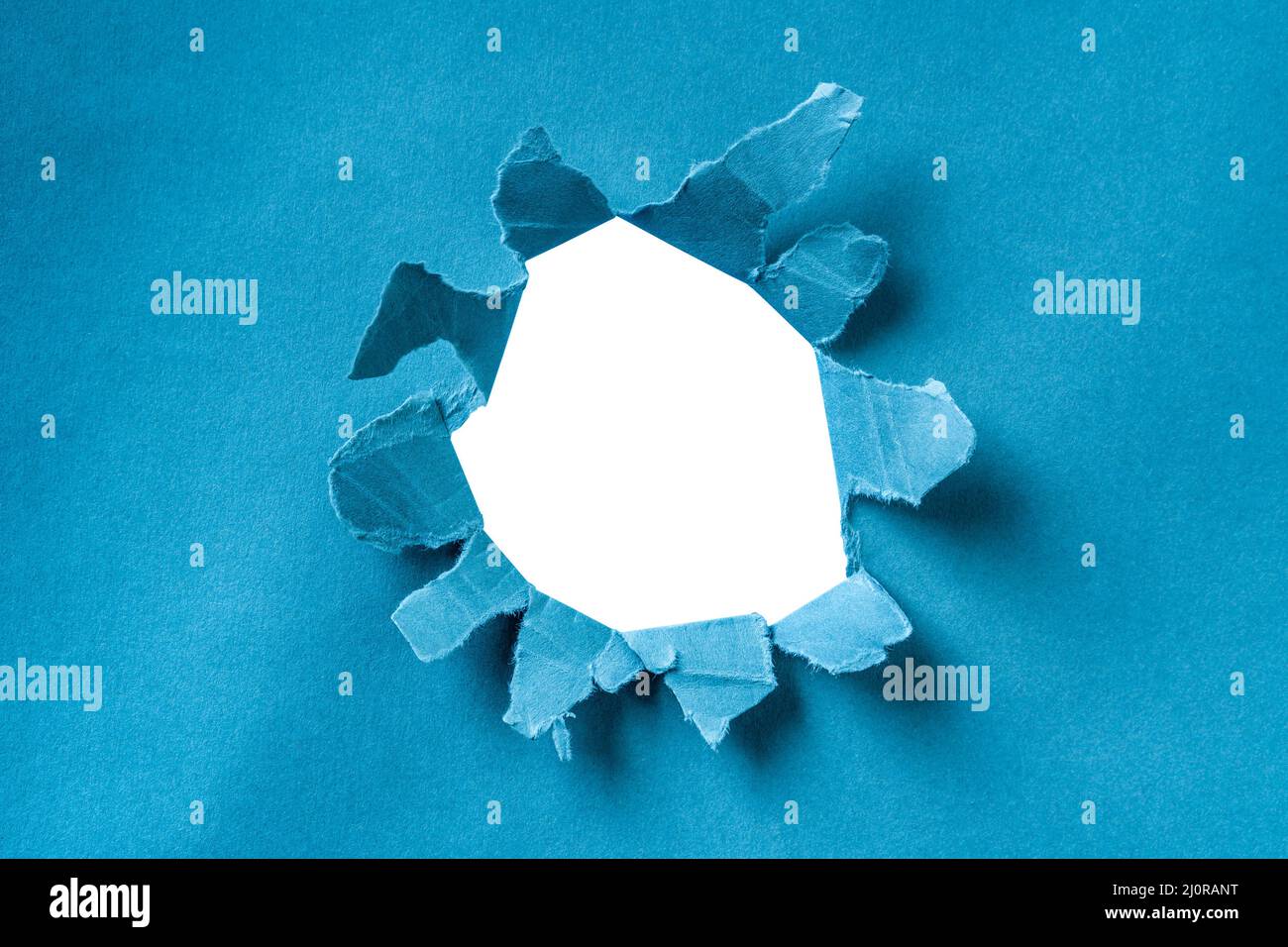 Breakthrough paper hole Stock Photo - Alamy