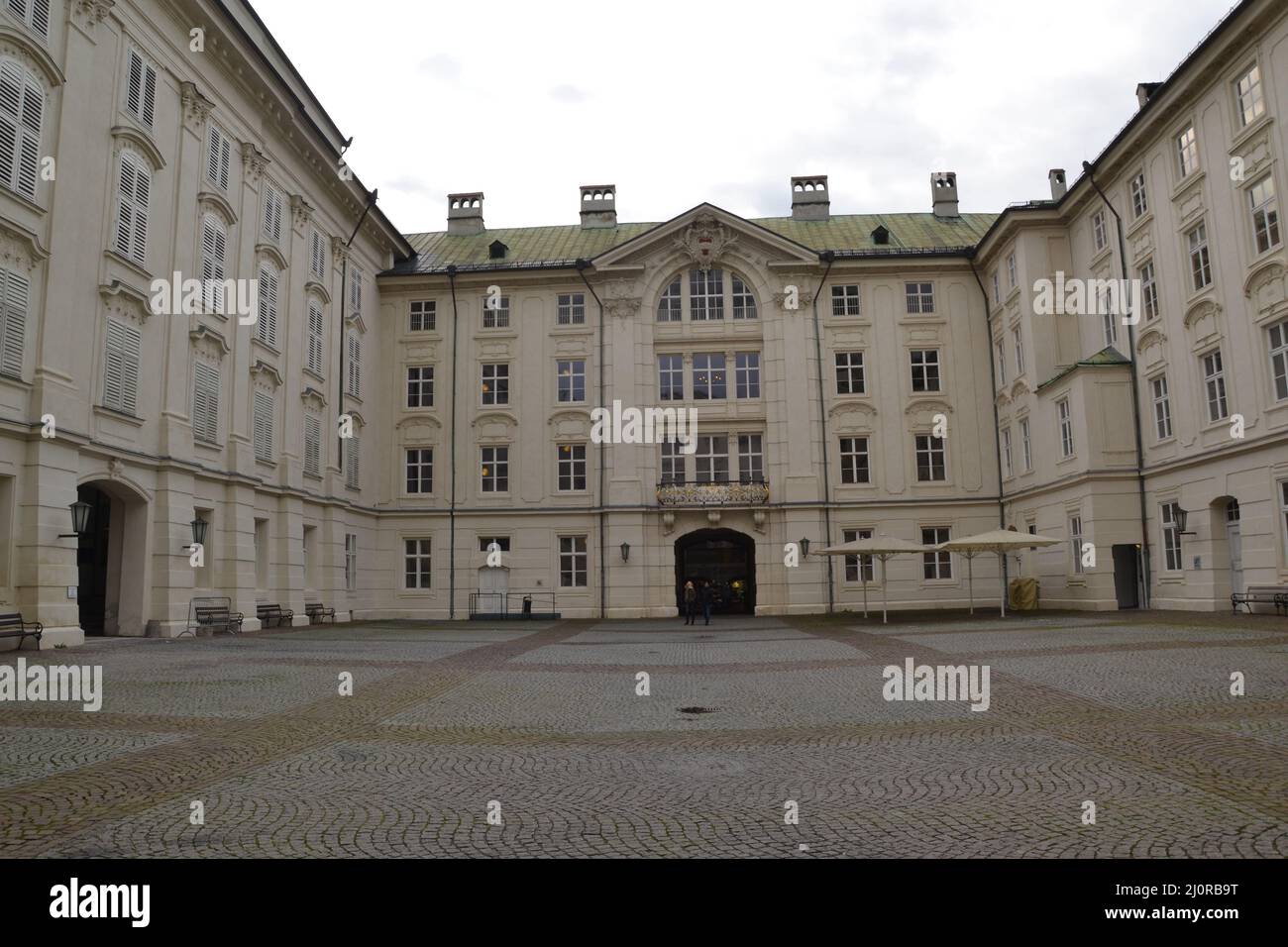 Paved yard of the Innsbrucker Hofgarten under cloudy sky in Austria ...