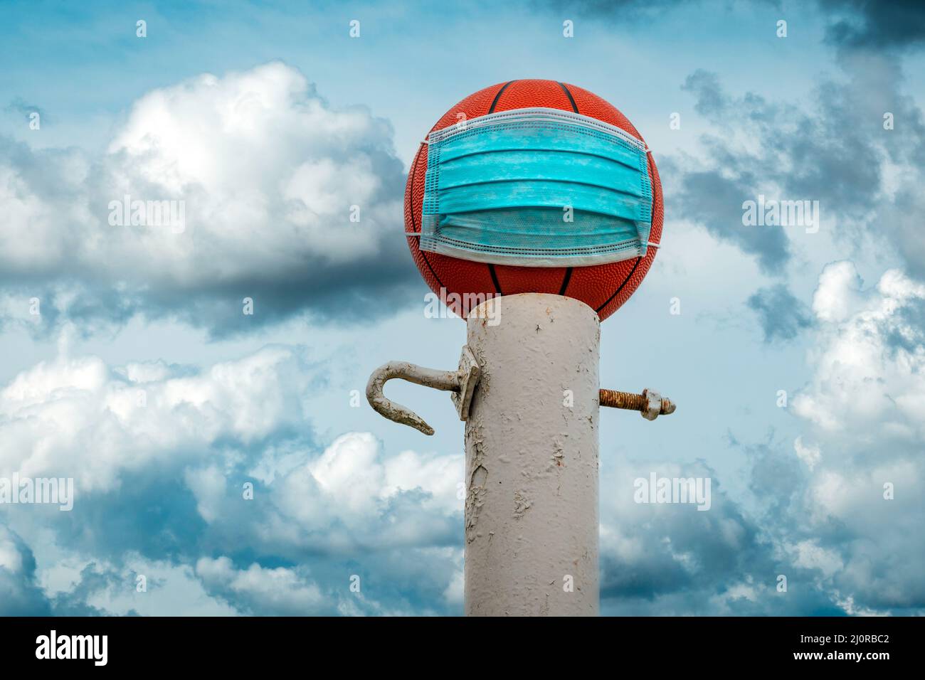 Basketball ball with a protection mask Stock Photo - Alamy