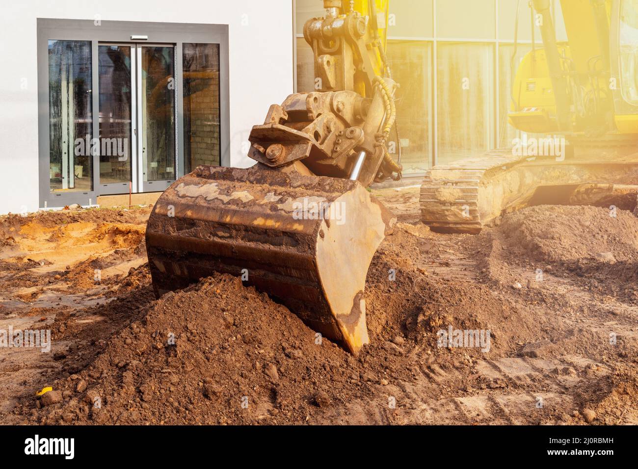 Working excavator shovel moving soil Stock Photo - Alamy