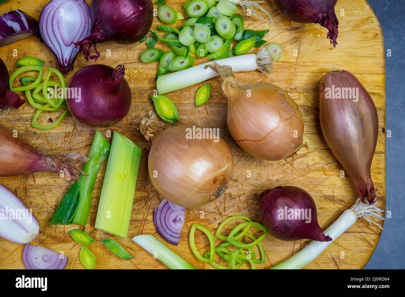 Different types of onion on wooden table. Onions, shallots, red and ...