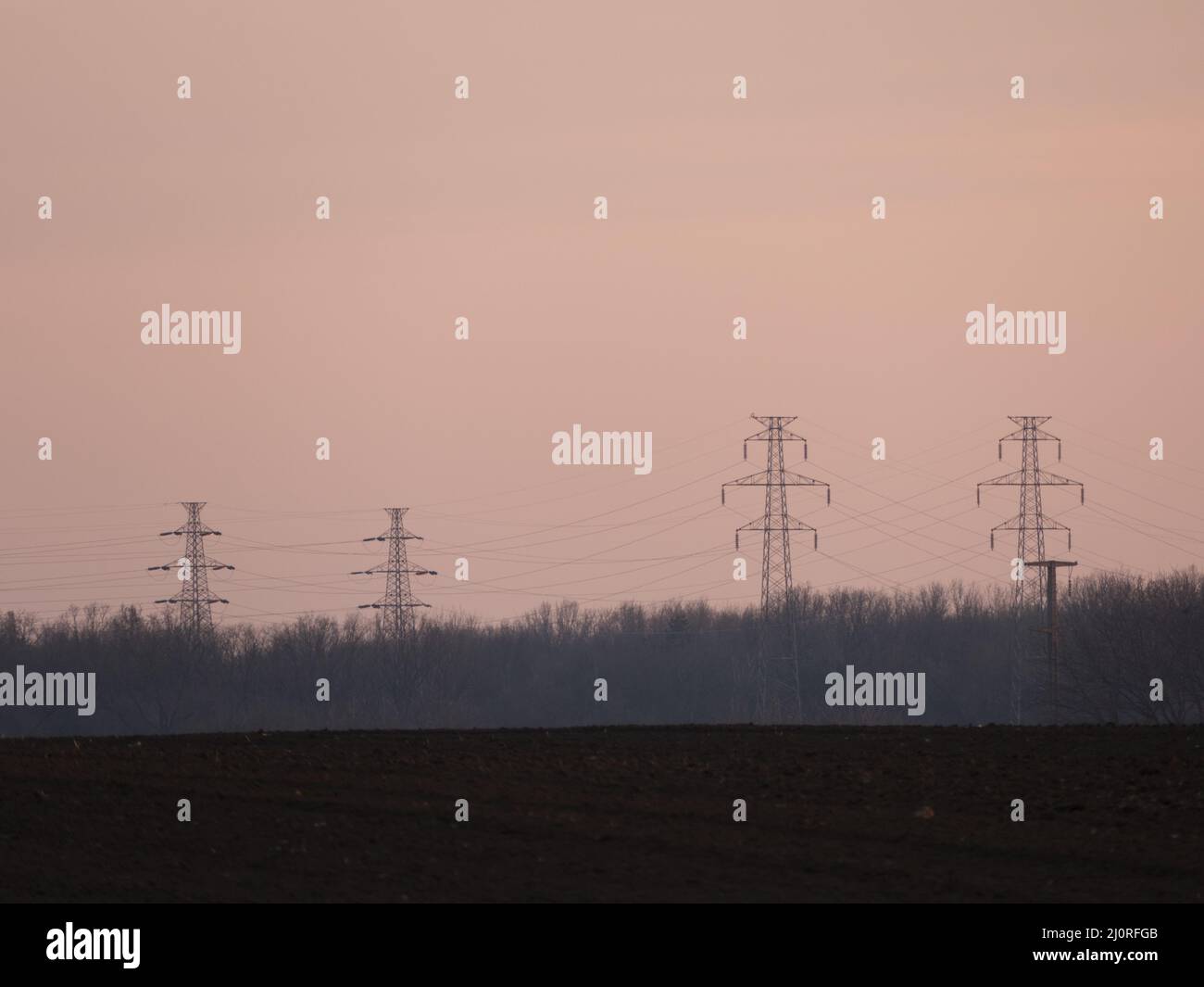 Landscape of a large field with electrical power lines in the ...