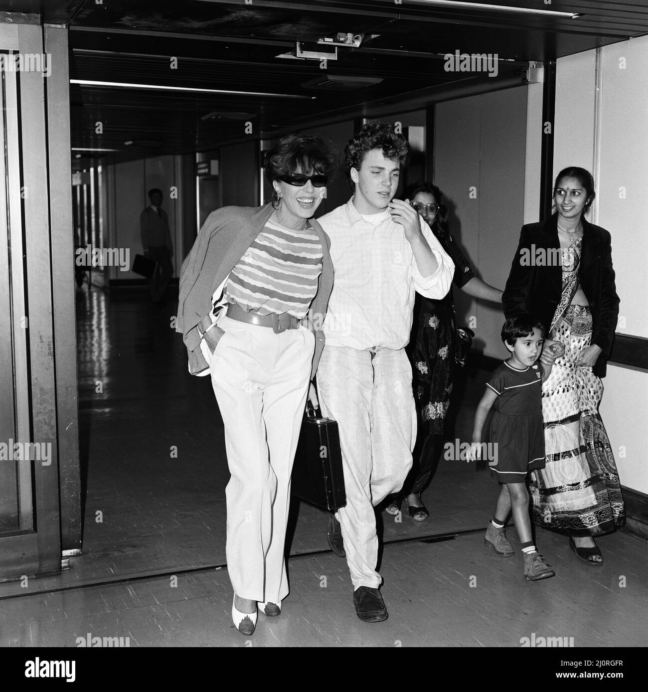 Joan Collins with her son Sacha, 17, arriving at Heathrow from Los ...